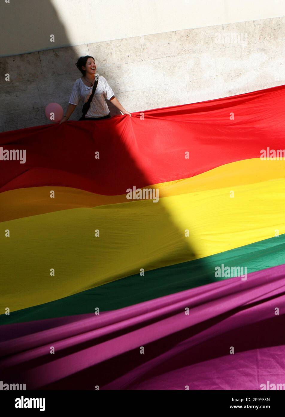 Revelers carry a giant flag during Lisbon's Gay Pride march Saturday ...