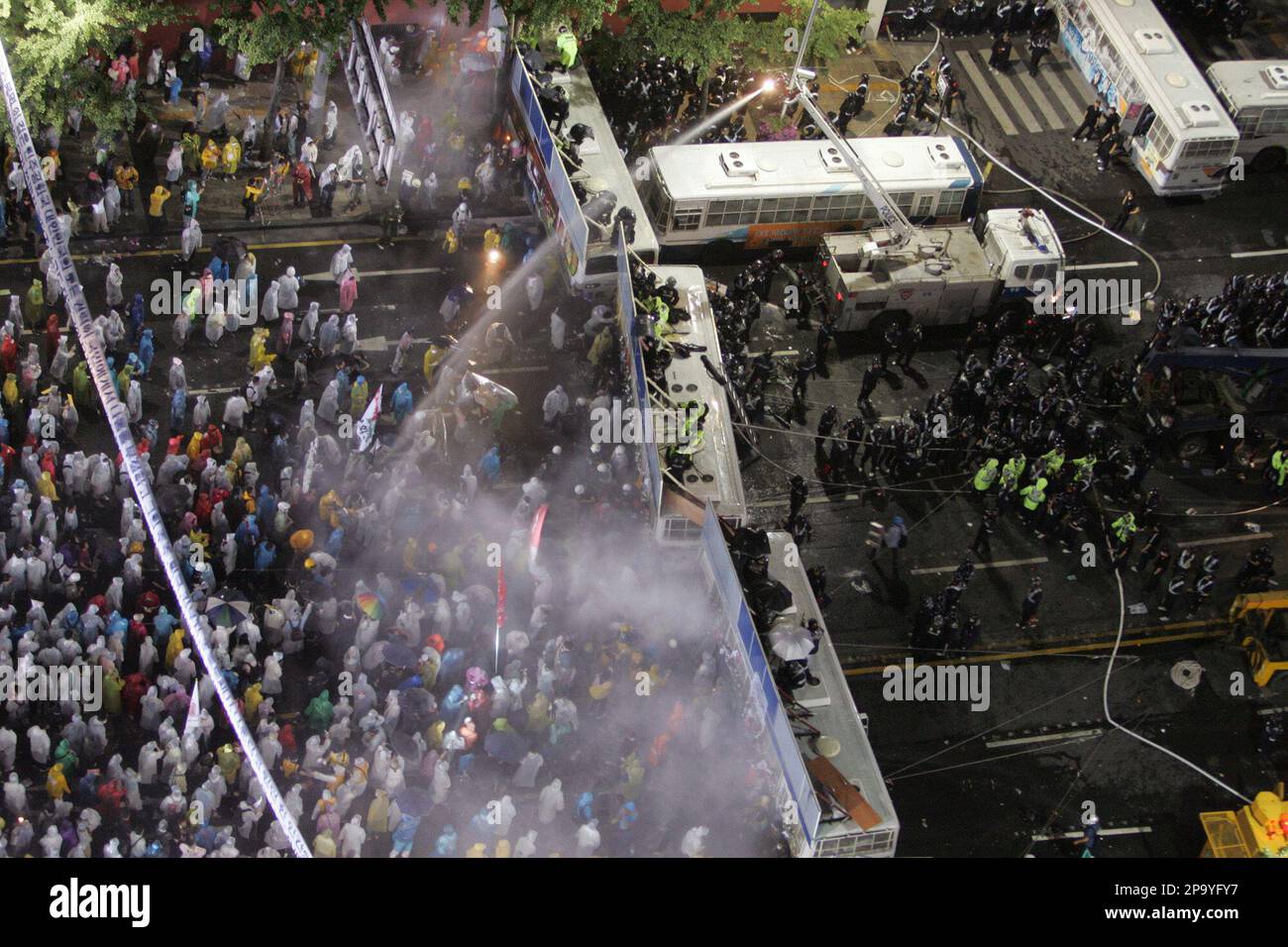 South Korean riot police officers spray water cannons to break up ...