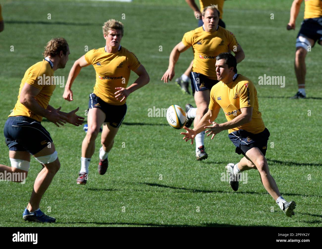 Australian rugby union player Adam Ashley-Cooper, right, off loads to ...
