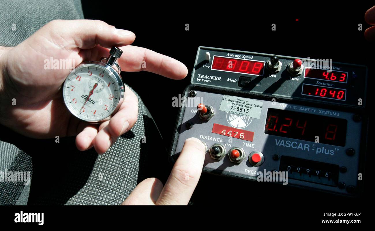 A officer uses a stop watch to calibrate his Vascar device during ...