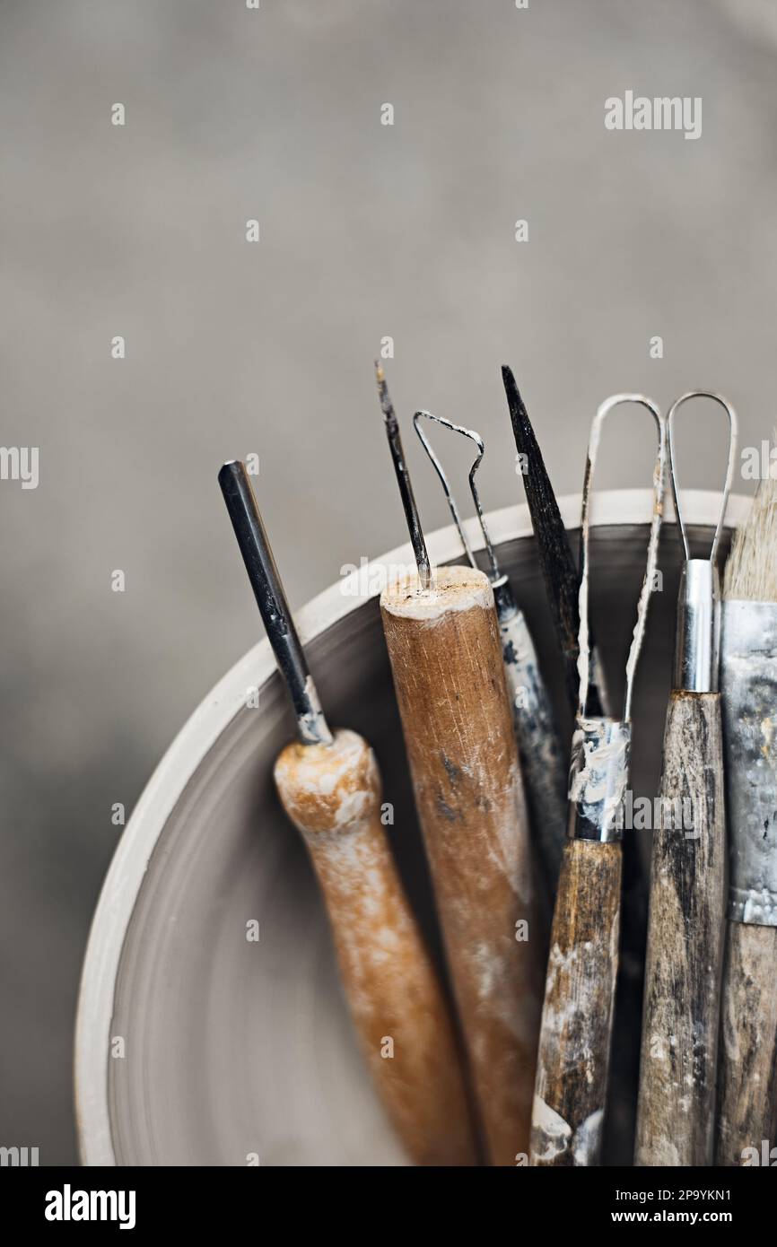 Tools for forming clay with pots in background , selective focus Stock ...