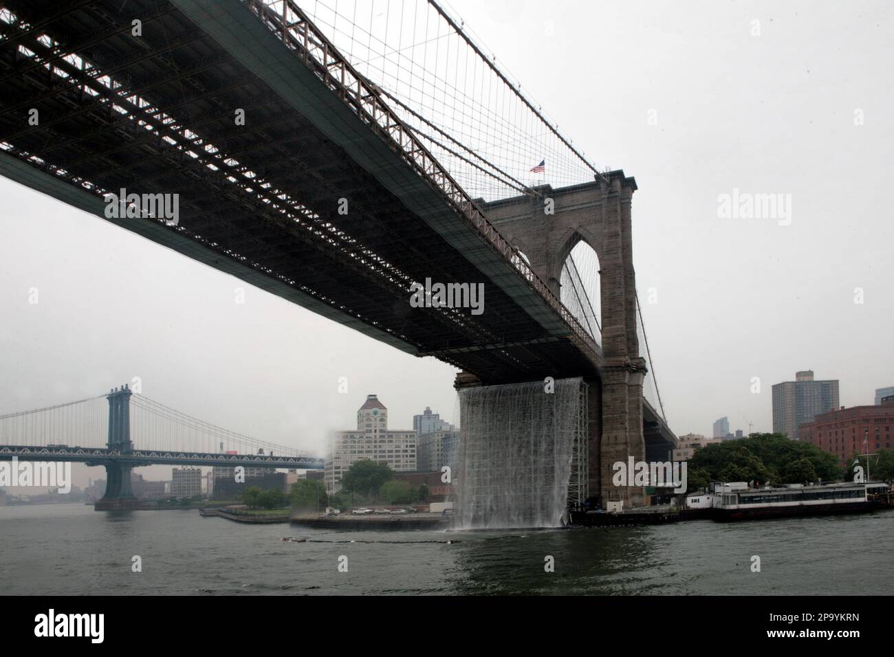 A man-made waterfall under the Brooklyn Bridge cascades into the East ...