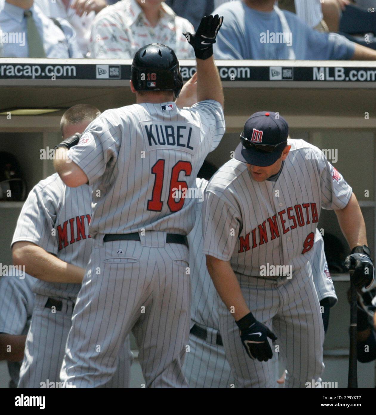 Minnesota Twins' Jason Kubel is congratualted at the dugout after ...