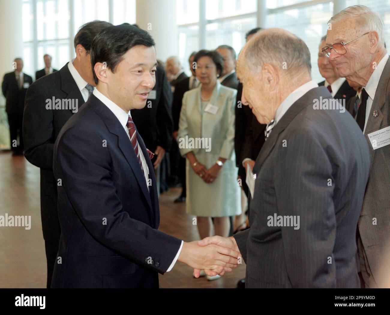 Japanese Crown Prince Naruhito, left, greets Charles Wolf Jr., senior ...