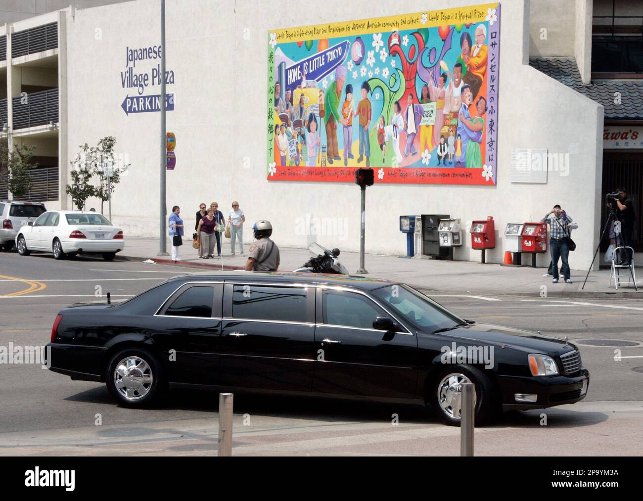 The limousine carrying Japanese Crown Prince Naruhito passes a colorful ...