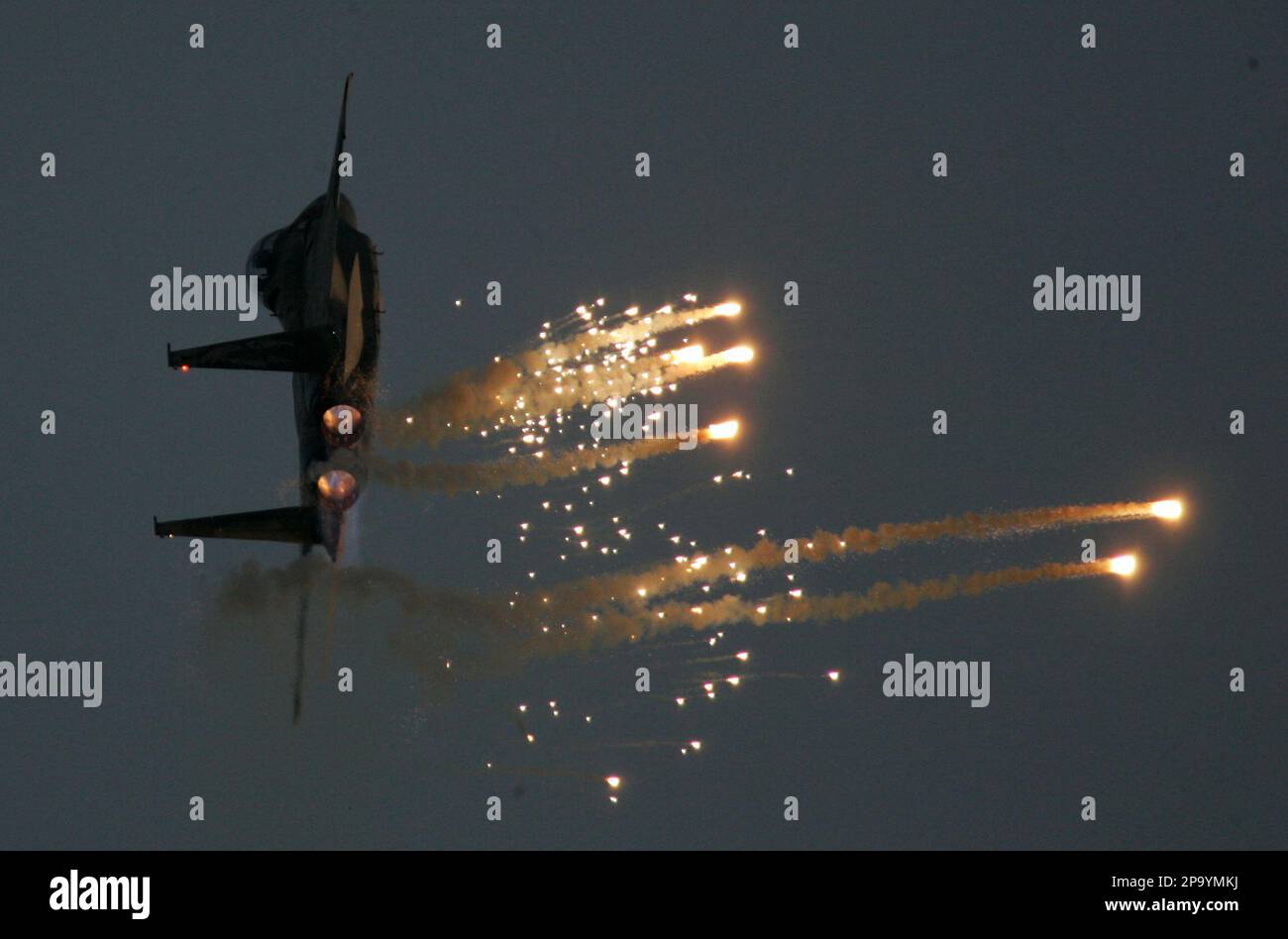 An Israeli Air Force fighter plane releases flares during an aerobatics ...
