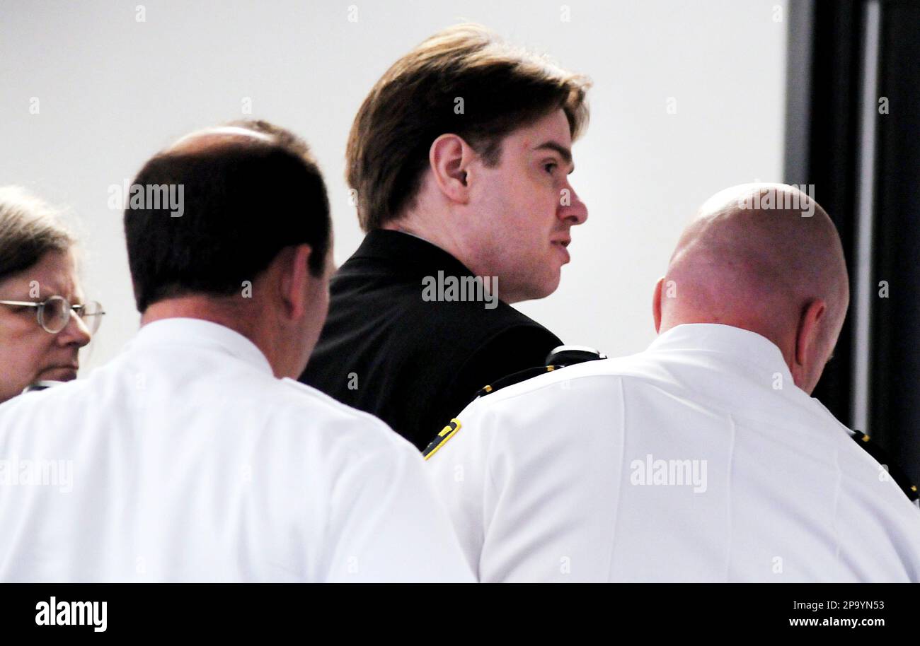 Neil Entwistle looks, center, looks to his parents as he is led from ...