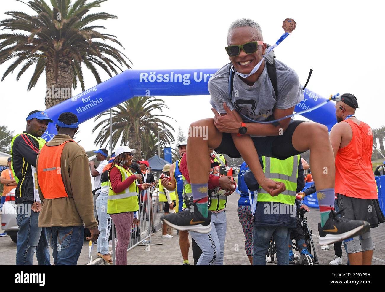 Swakopmund, Namibia. 11th Mar, 2023. A runner celebrates after crossing ...