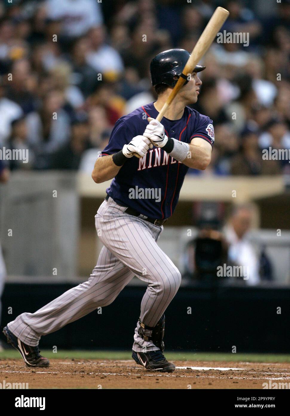 Minnesota Twins' Joe Mauer watches his two-run double head for the left ...
