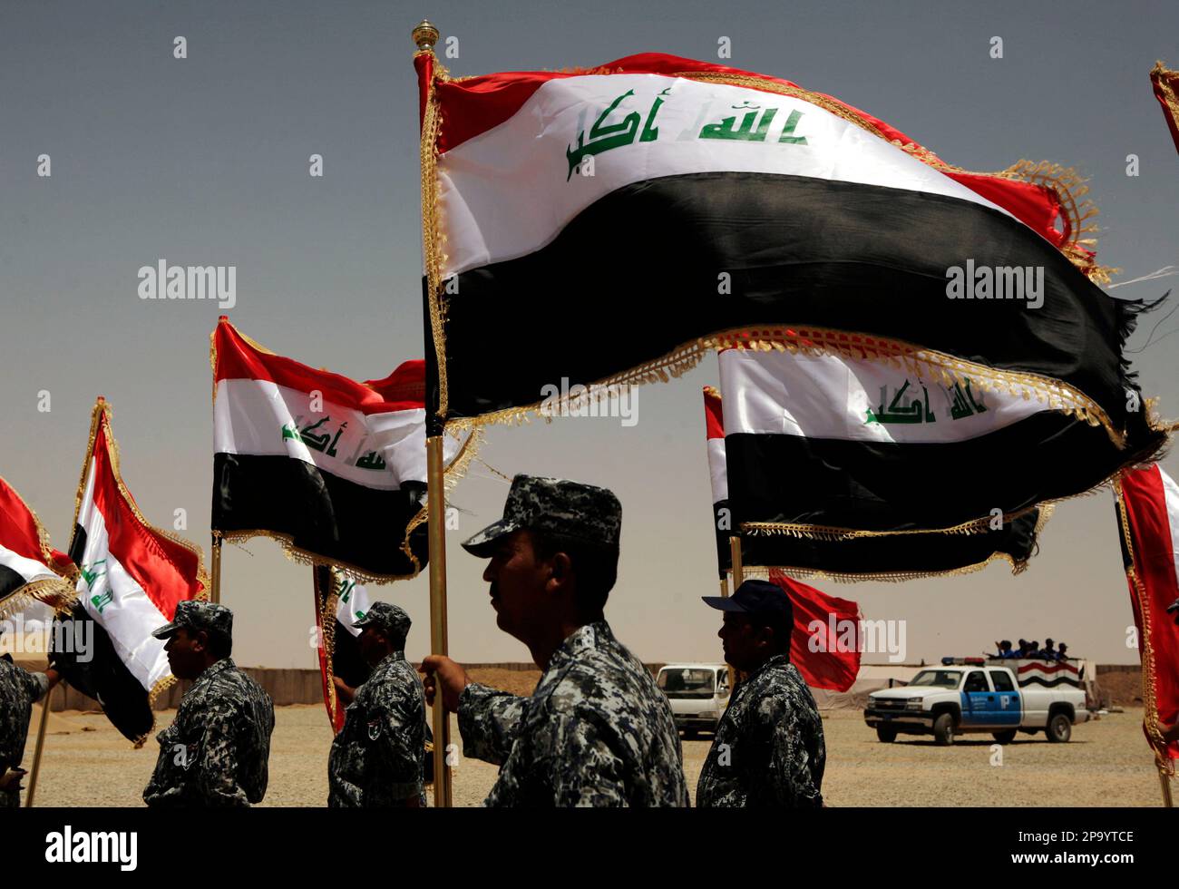 Iraqi police cadets stand in formation at a graduation ceremony at the ...