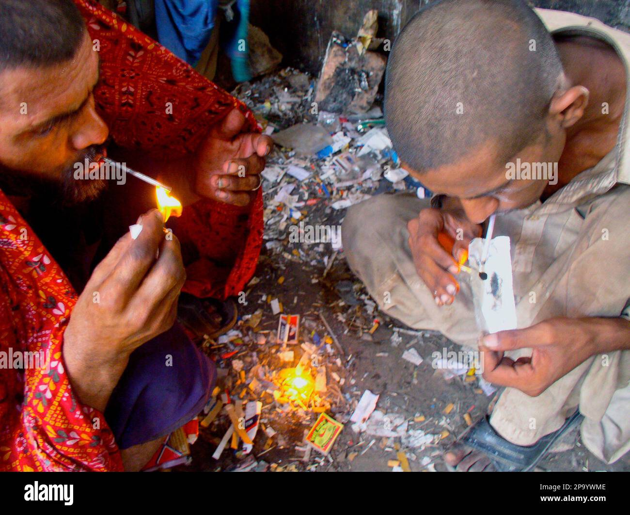 Pakistani drug addicts smoke heroin in a slum of Hyderabad, 160 ...