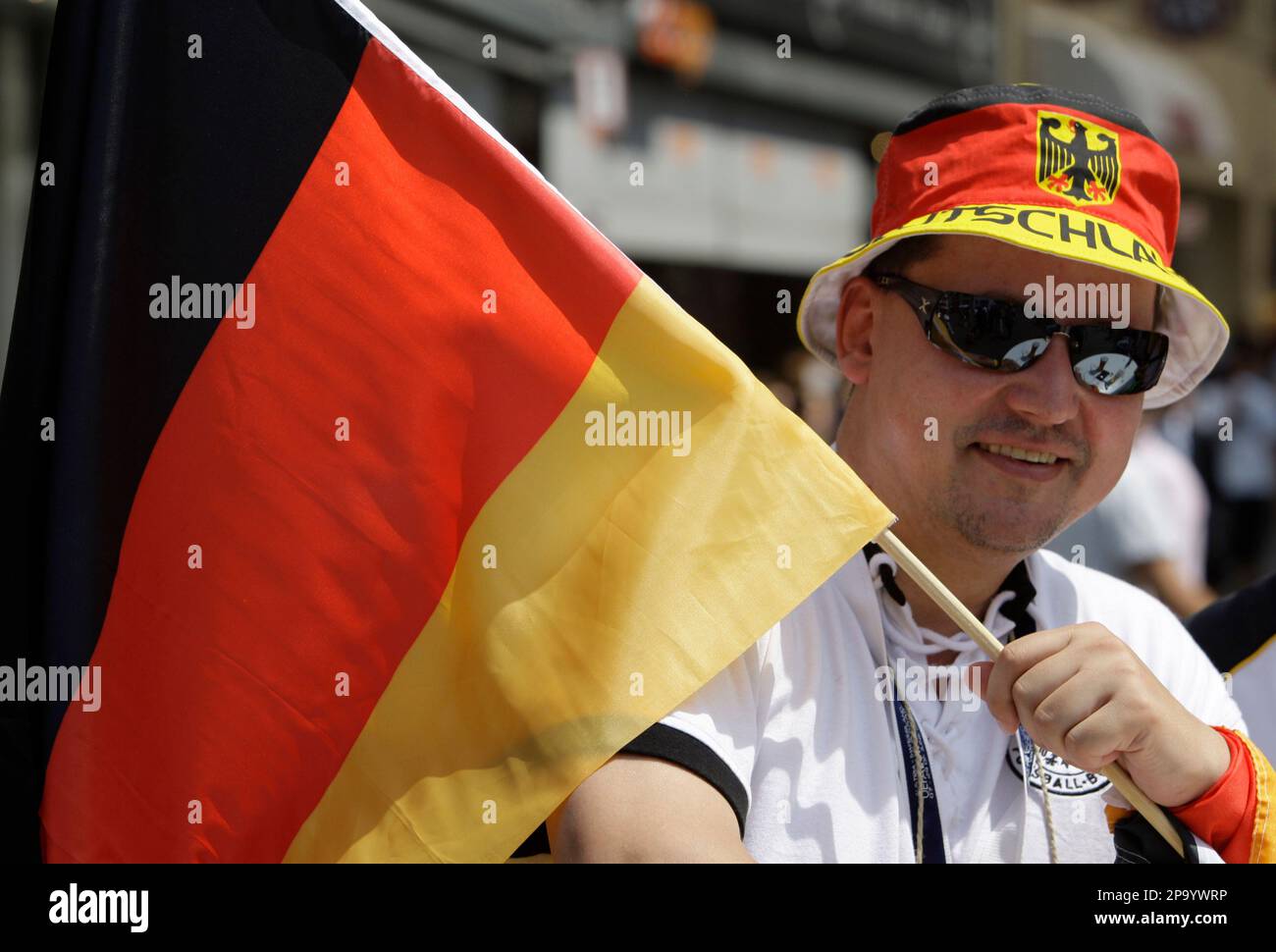 A German soccer fan poses with his national flag in downtown in Basel ...