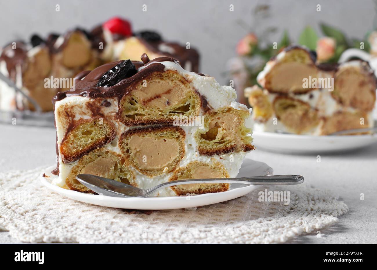 Profiterole Cake, cut into portions, one piece in the foreground Stock ...