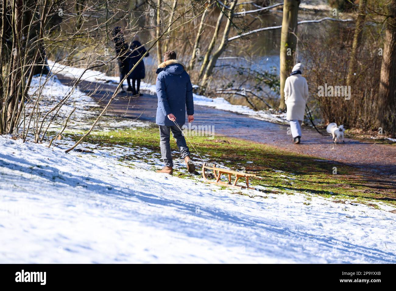 Hamburg, Germany. 11th Mar, 2023. Patrick (36) pulls a sled along a ...