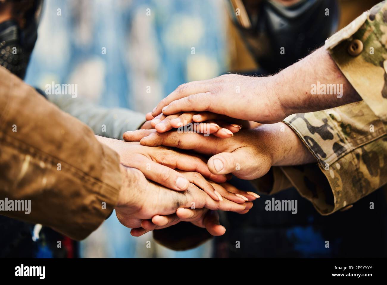 Motivation, paintball team or hands in huddle on a mission, friends or ...