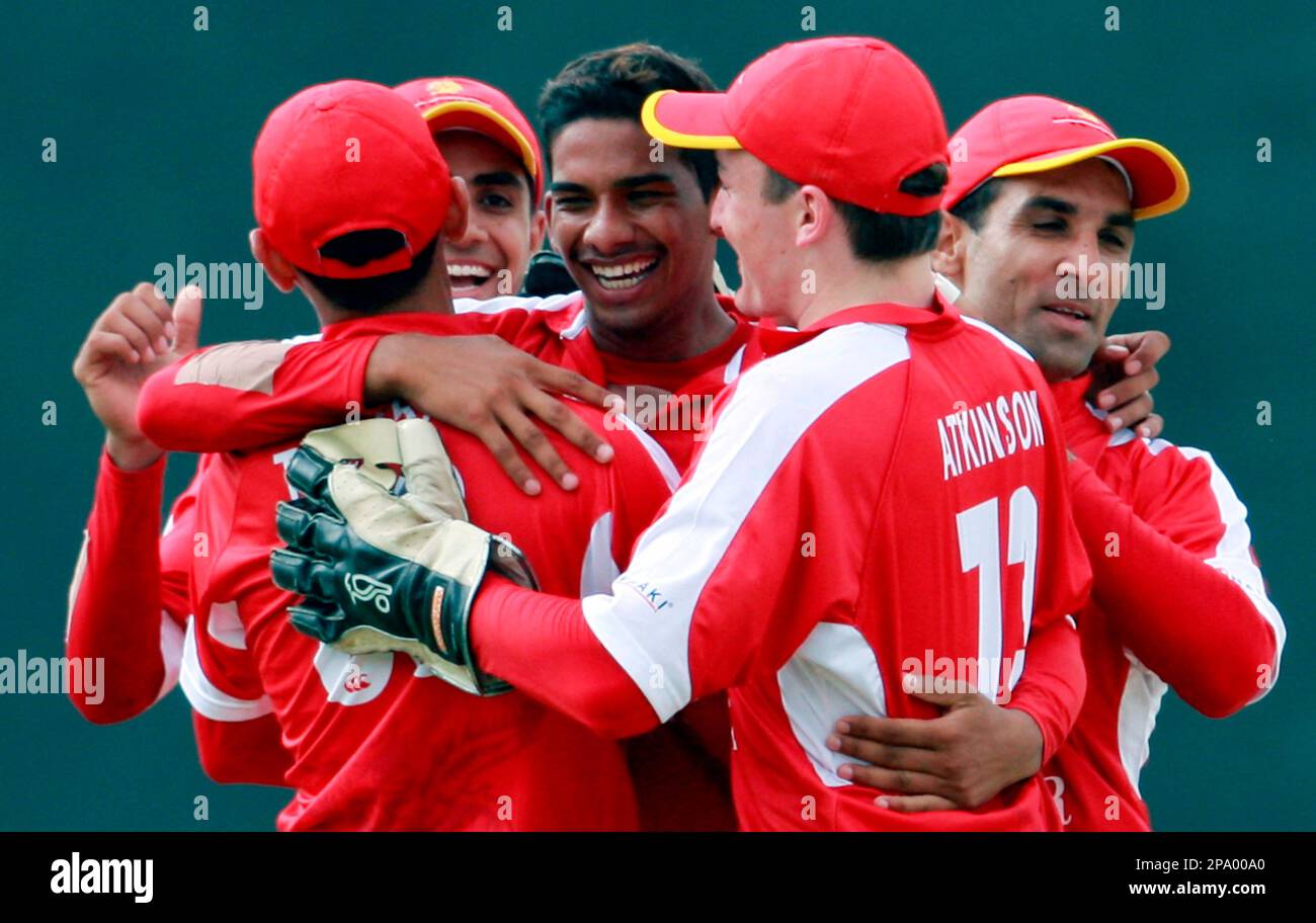 Hong Kong's wicketkeeper Jamie Atkinson. second from right, joins ...