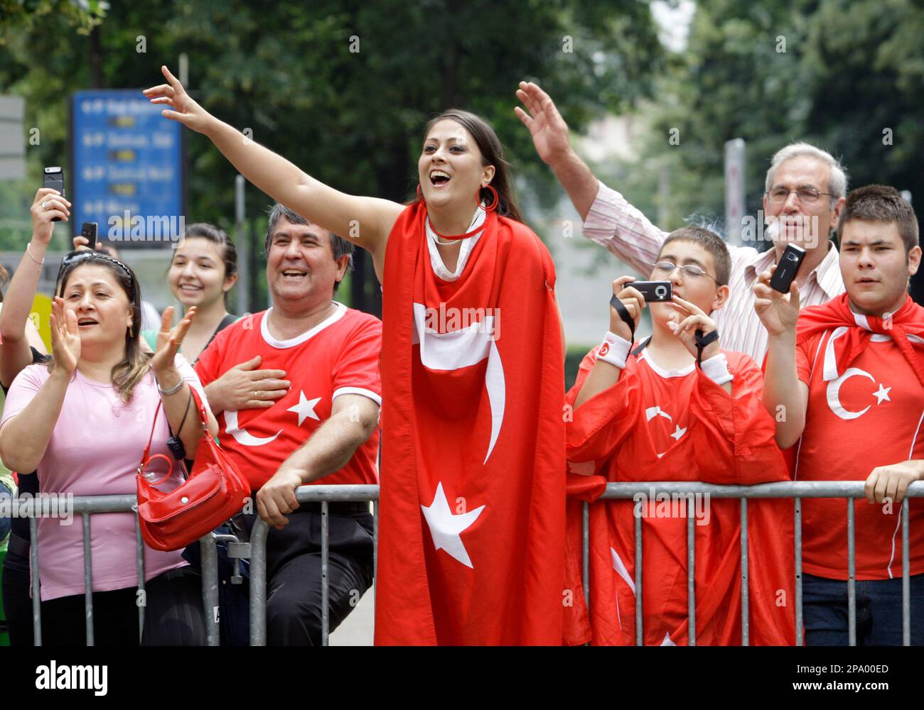 Turkish soccer fans cheer as the bus carrying the national soccer team ...