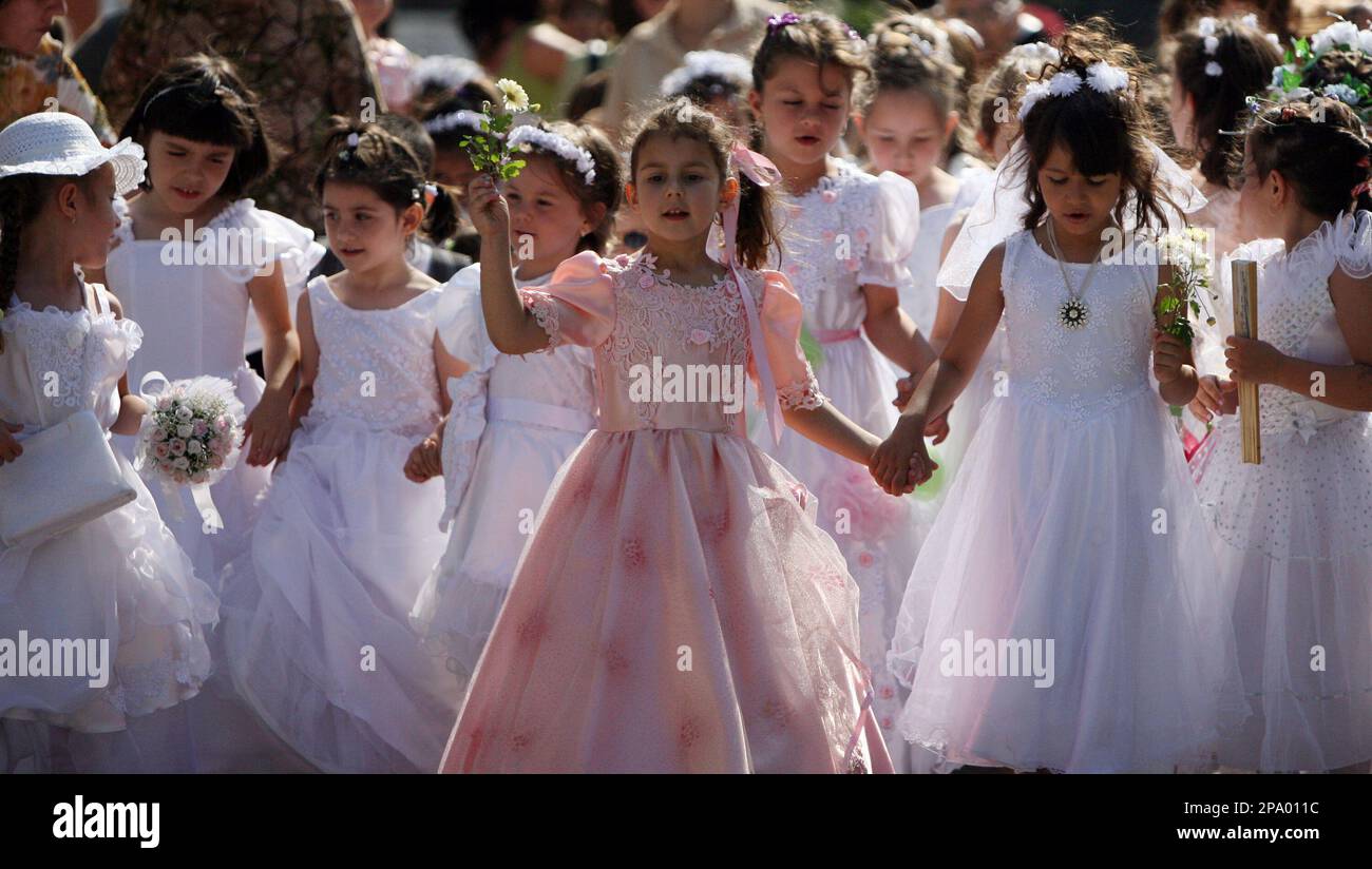 Girls dressed in wedding dress attends the celebrations of the Orthodox ...