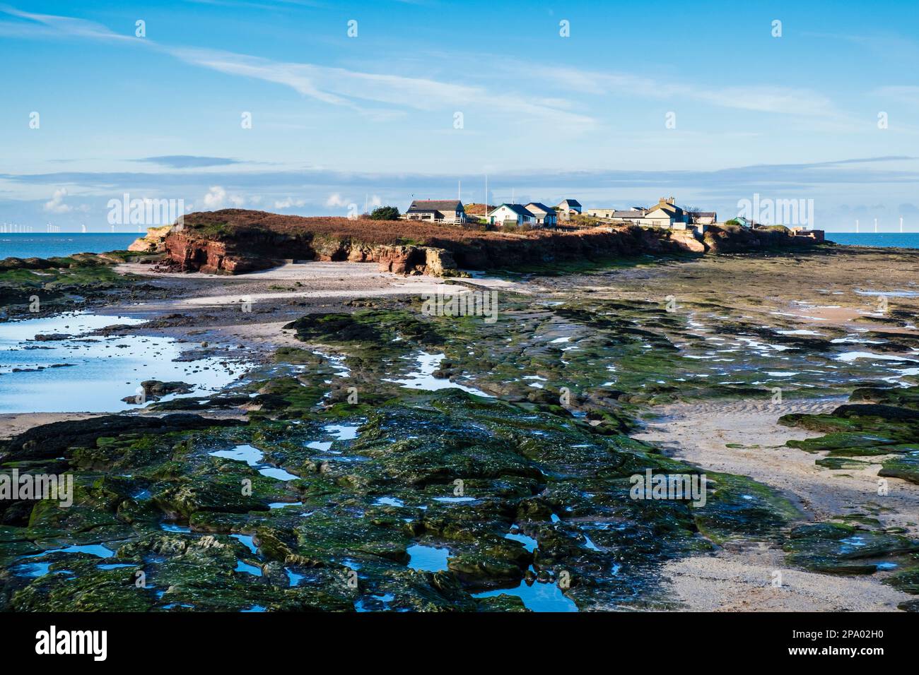 View across rock pools to tidal Hilbre Island from Little Hilbre island ...