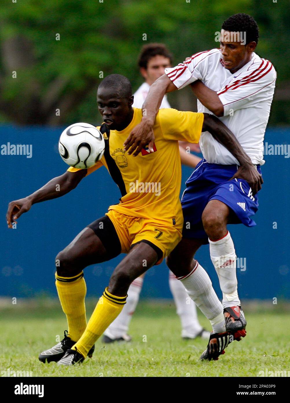 Antigua and Barbuda's Gregory Gason, left, fights for the ball with ...