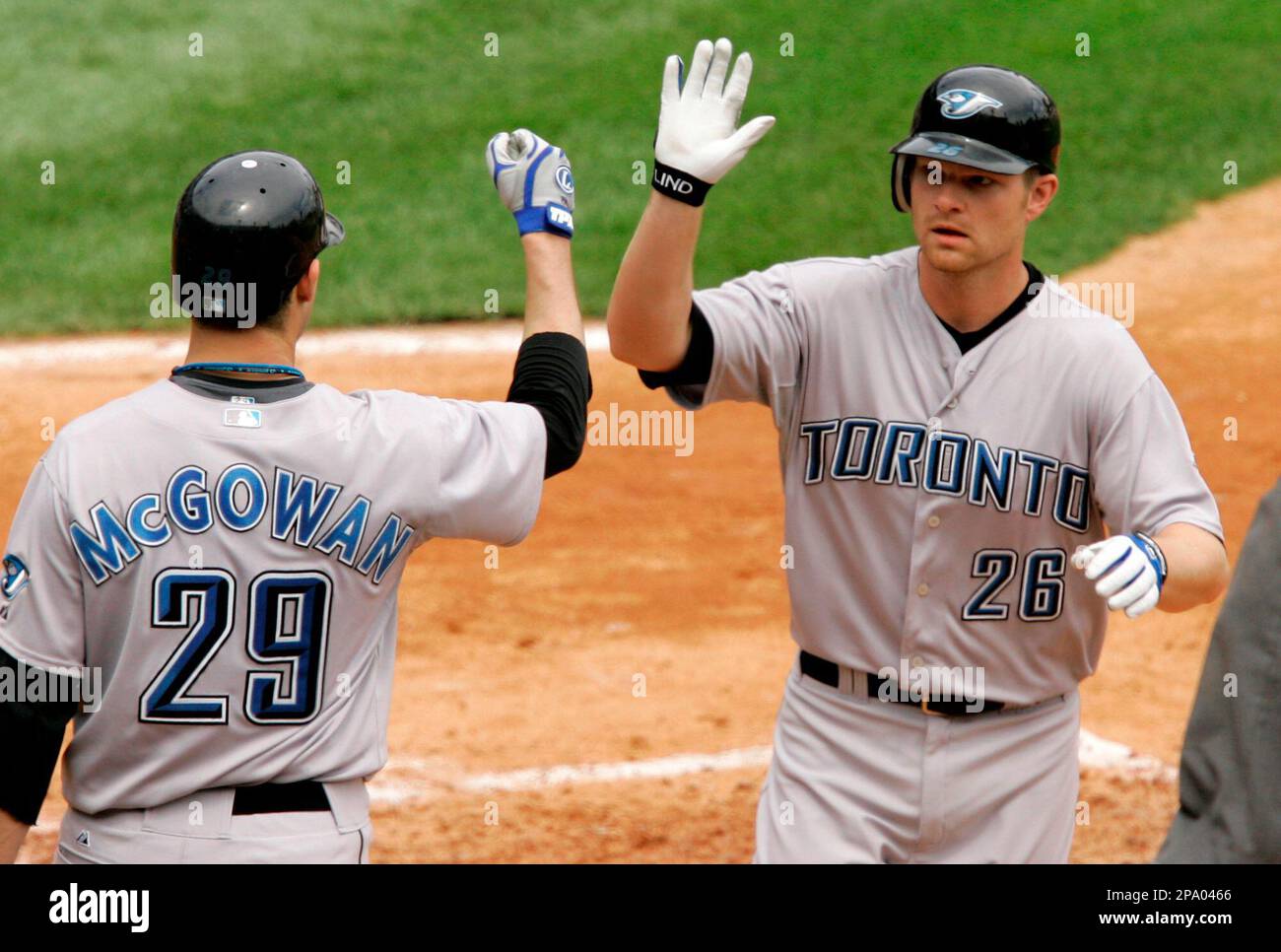 Toronto Blue Jays' Adam Lind (26) is greeted by teammate Dustin McGowan ...