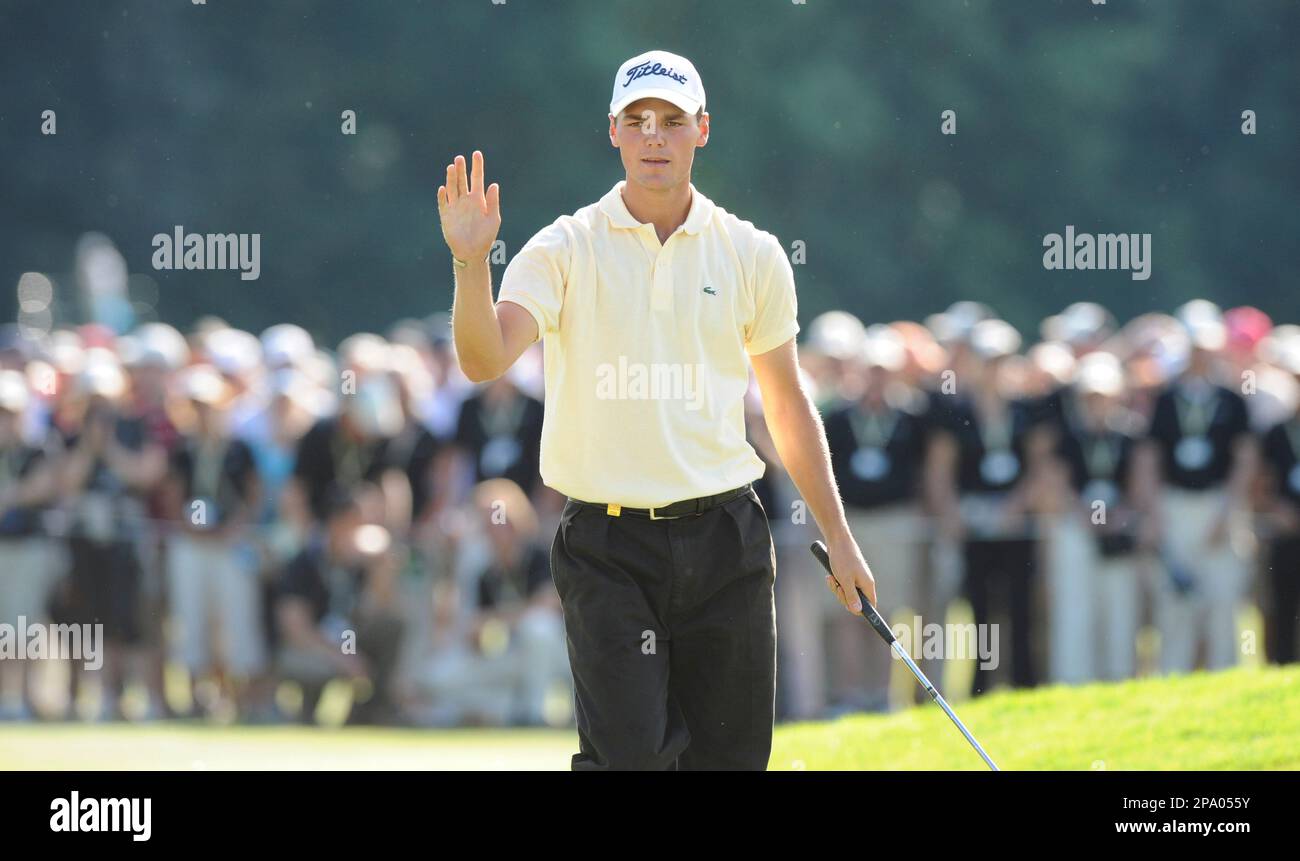German golfer Martin Kaymer waves after his shot at the 18th hole ...