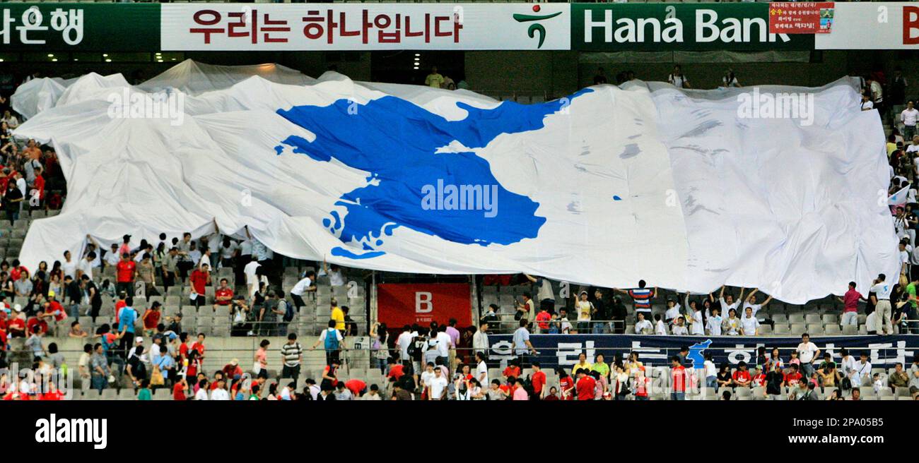 South Korean soccer fans spread a huge unification flag during a soccer ...
