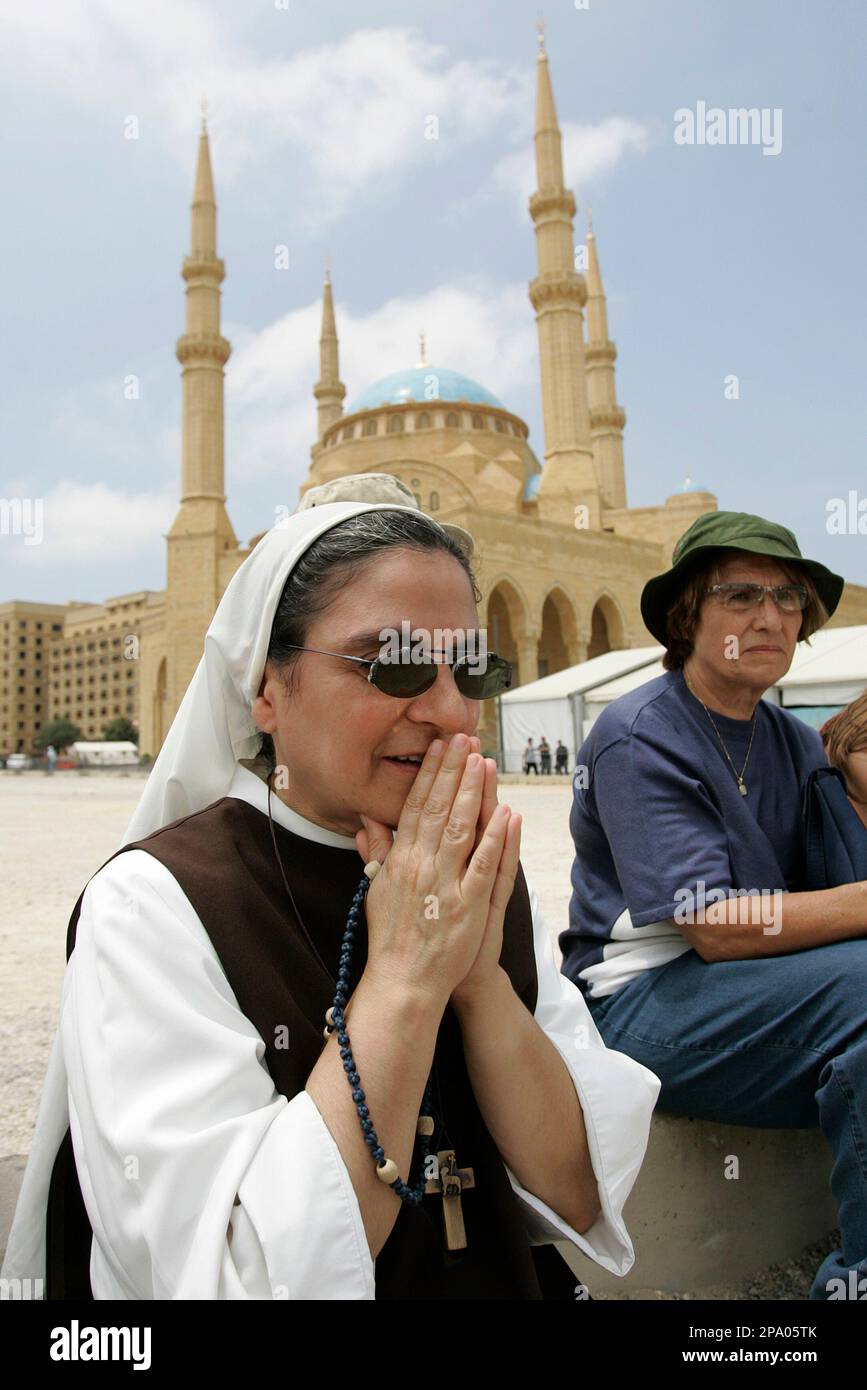 A Lebanese nun, prays as she sits on the ground in front of Mohammed al ...