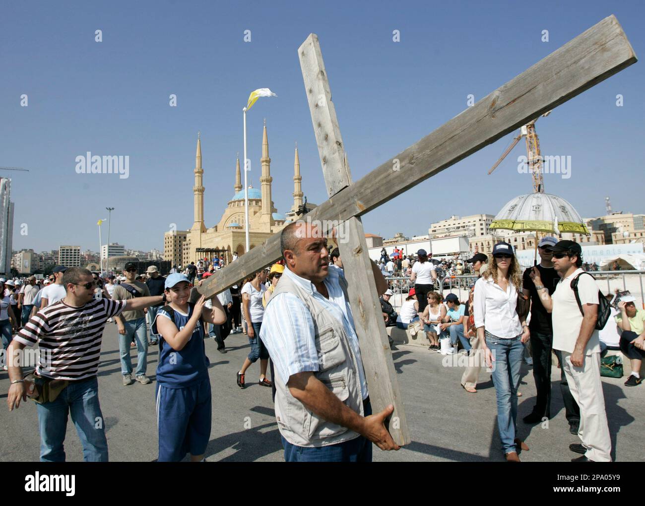Lebanese Christian faithful carry a big wooden Cross, in front of ...