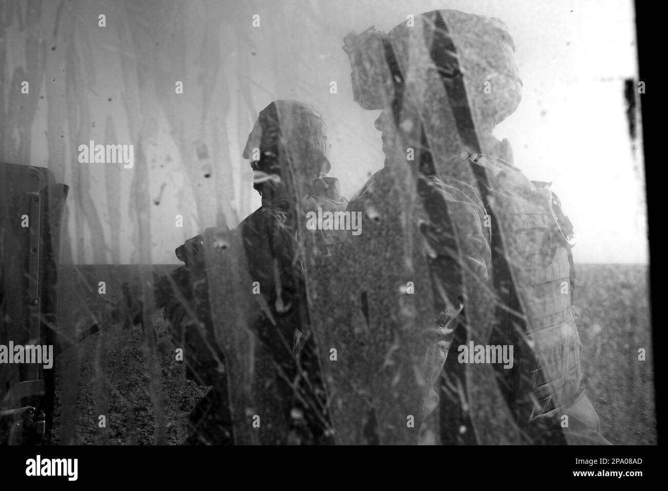 Marines from the 24th Marine Expeditionary Unit are seen through a dust ...