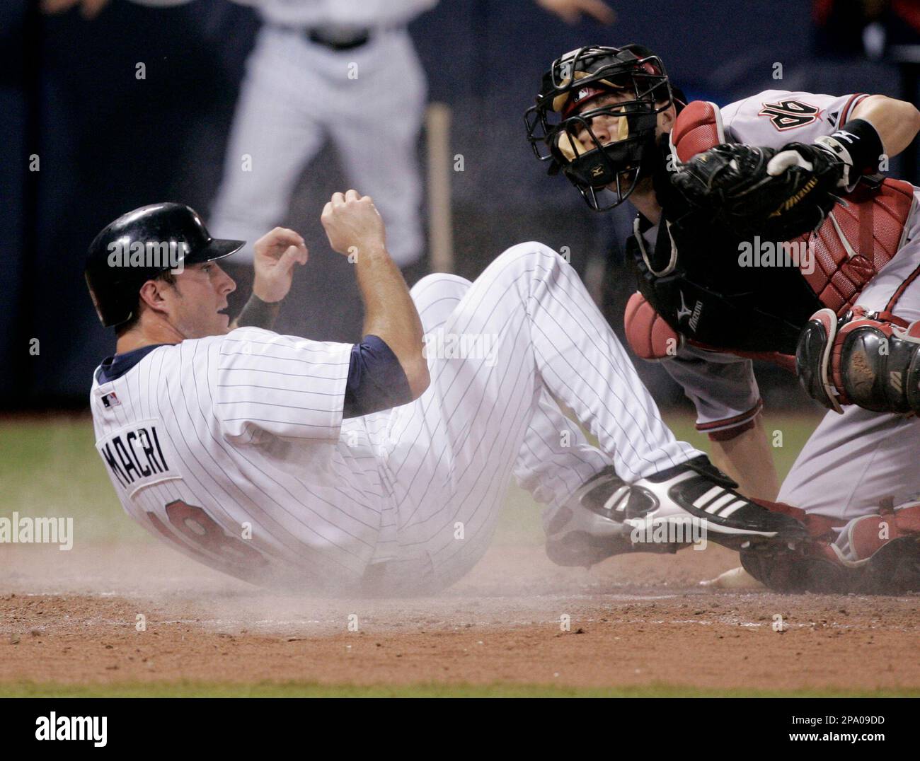 Minnesota Twins' Matt Macri, left, beats the tag by Arizona Diamondbacks catcher Miguel Montero ...
