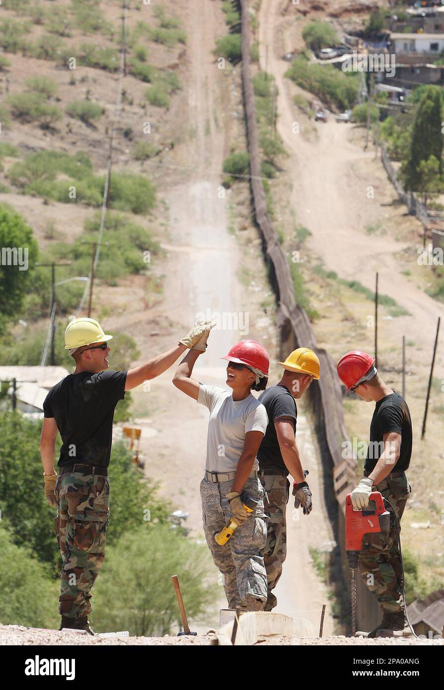 With the border fence separating the United State from Mexico looming ...