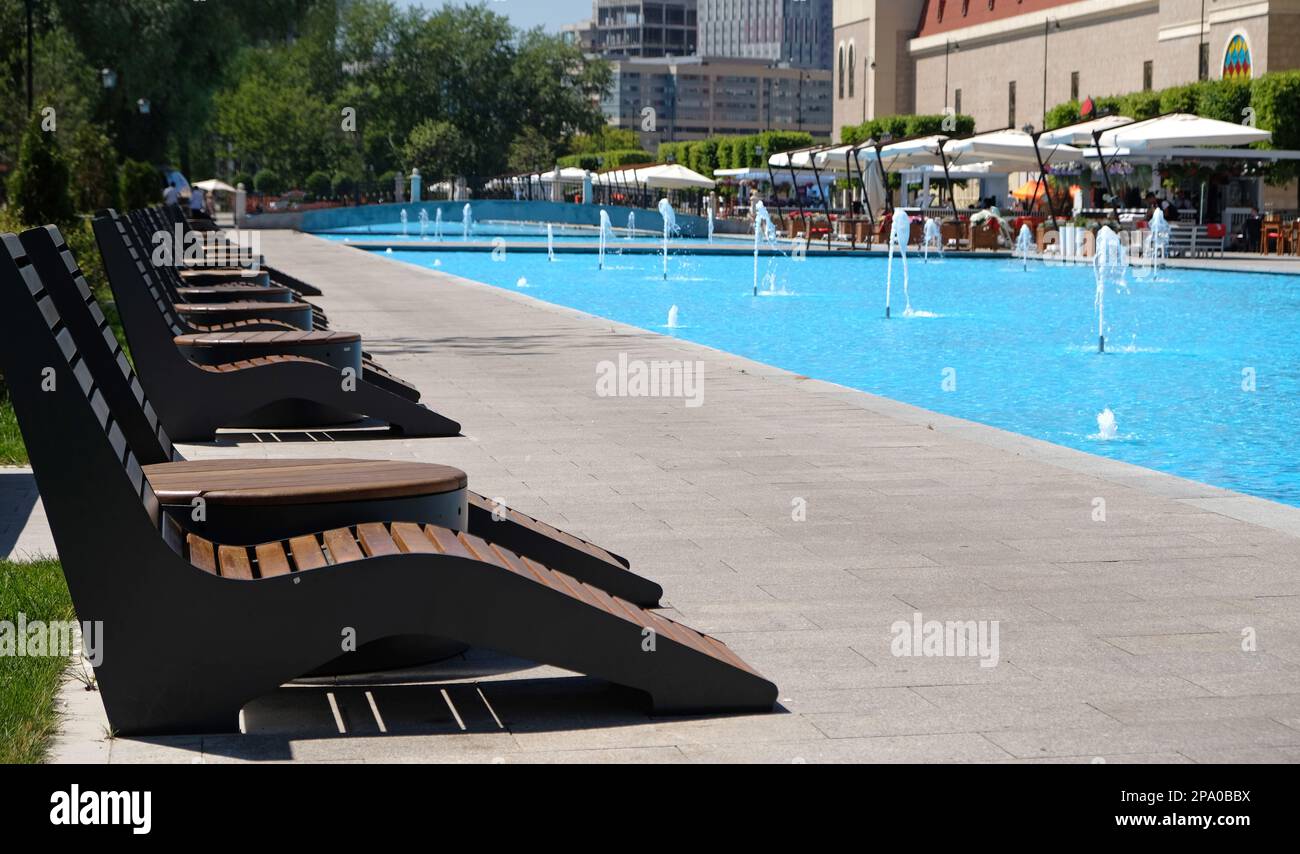 A recreation and relaxation area by the pool in a hotel or a fountain ...
