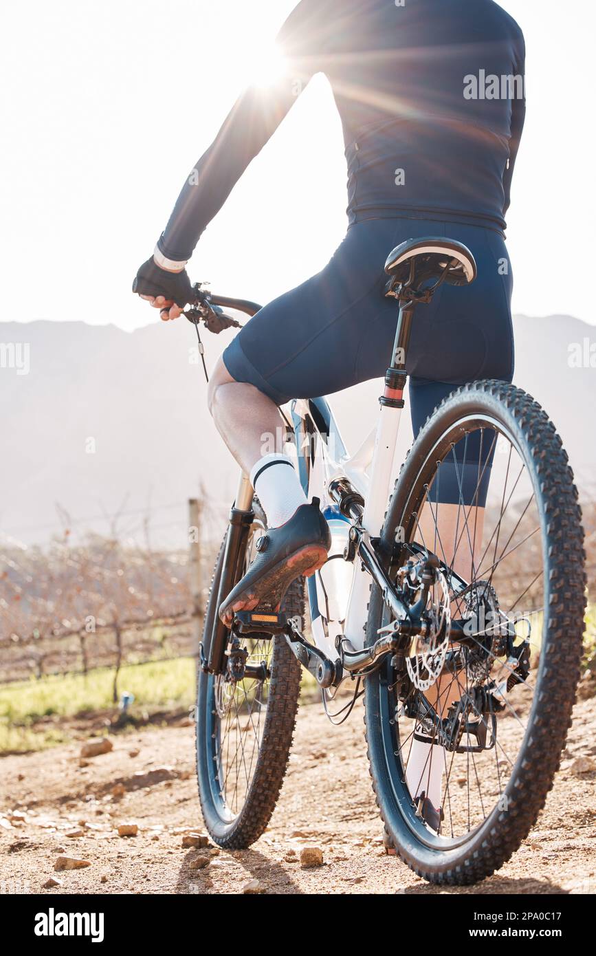 Back of man, bicycle and cycling in nature, countryside and training ...