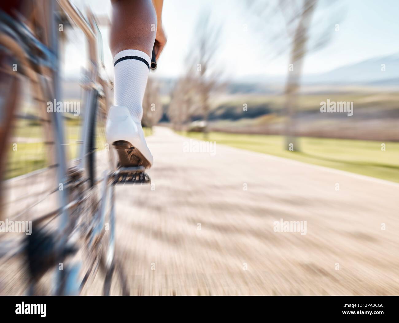 Back of man, cycling wheel and motion blur on park path, exercise and ...