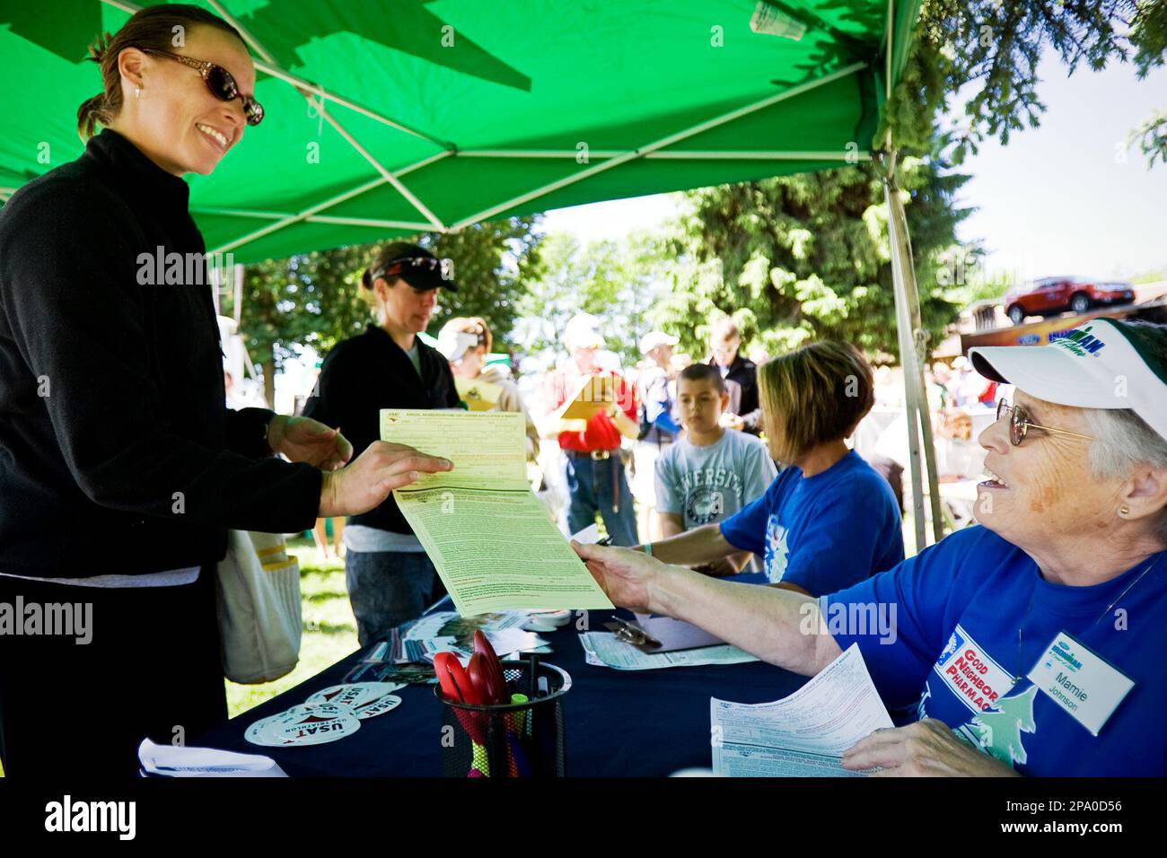 Kelly Lynch of Otis Orchards, Washington, left, registers as a ...
