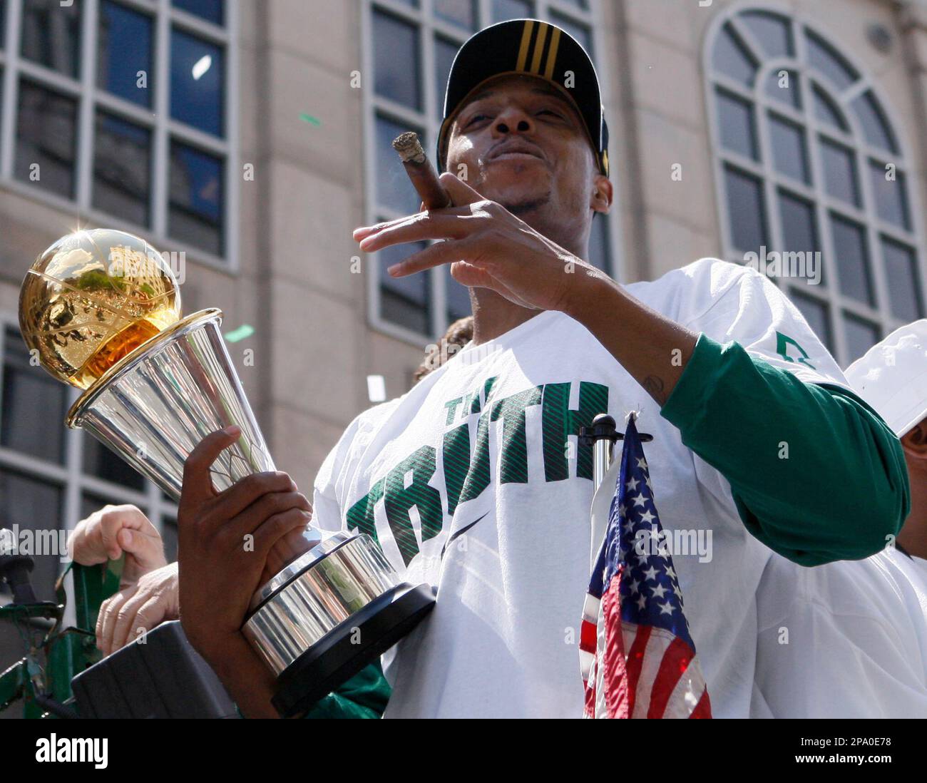 Boston Celtics captain Paul Pierce puffs on a cigar while holding the ...
