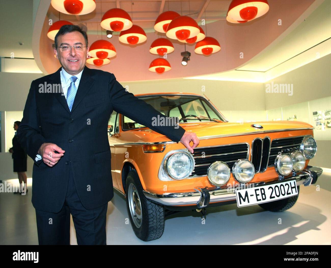 Norbert Reithofer, CEO of German car maker BMW, poses next to a BMW ...