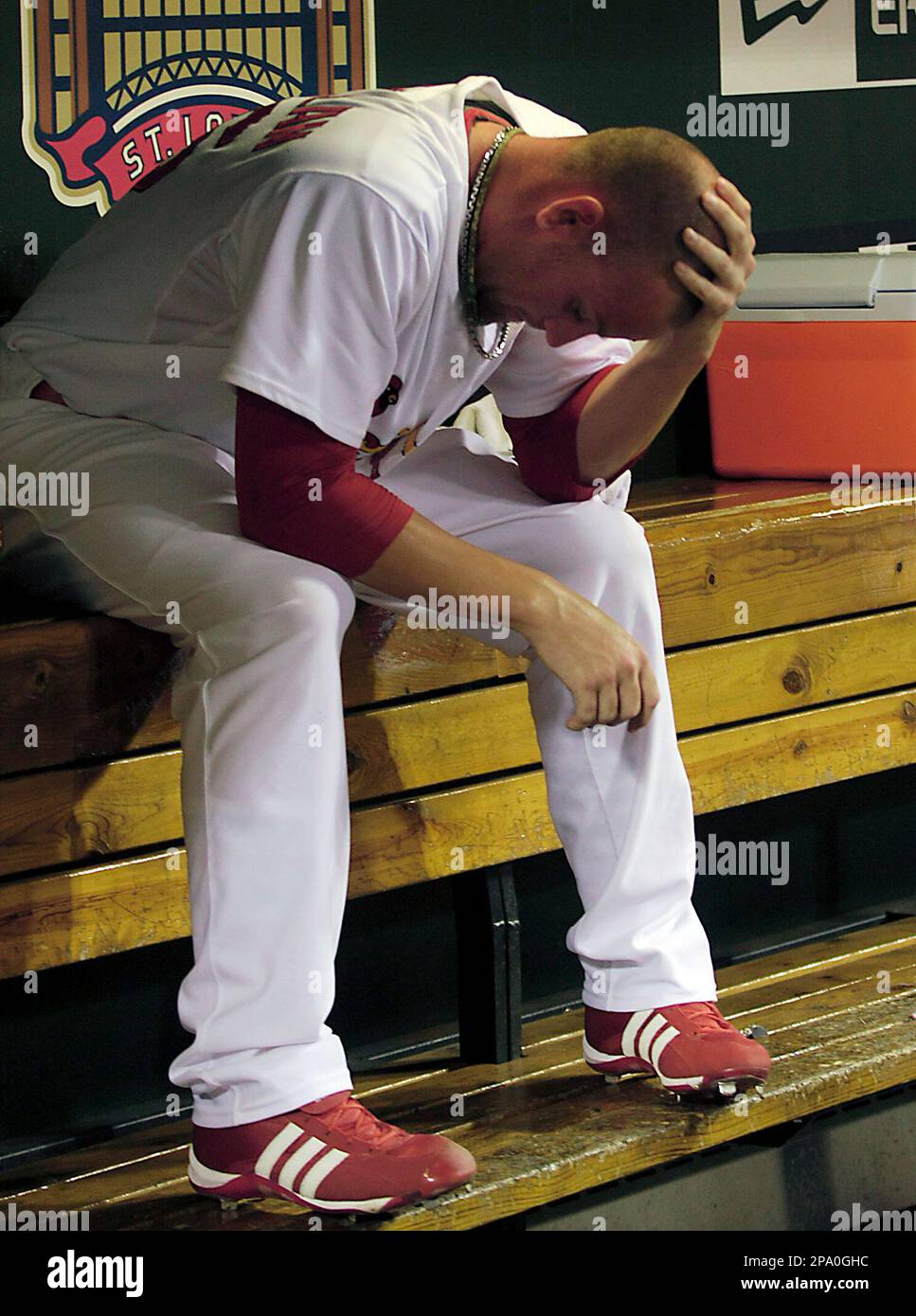 St. Louis Cardinals' Kyle McClellan sits in the dugout after giving up ...