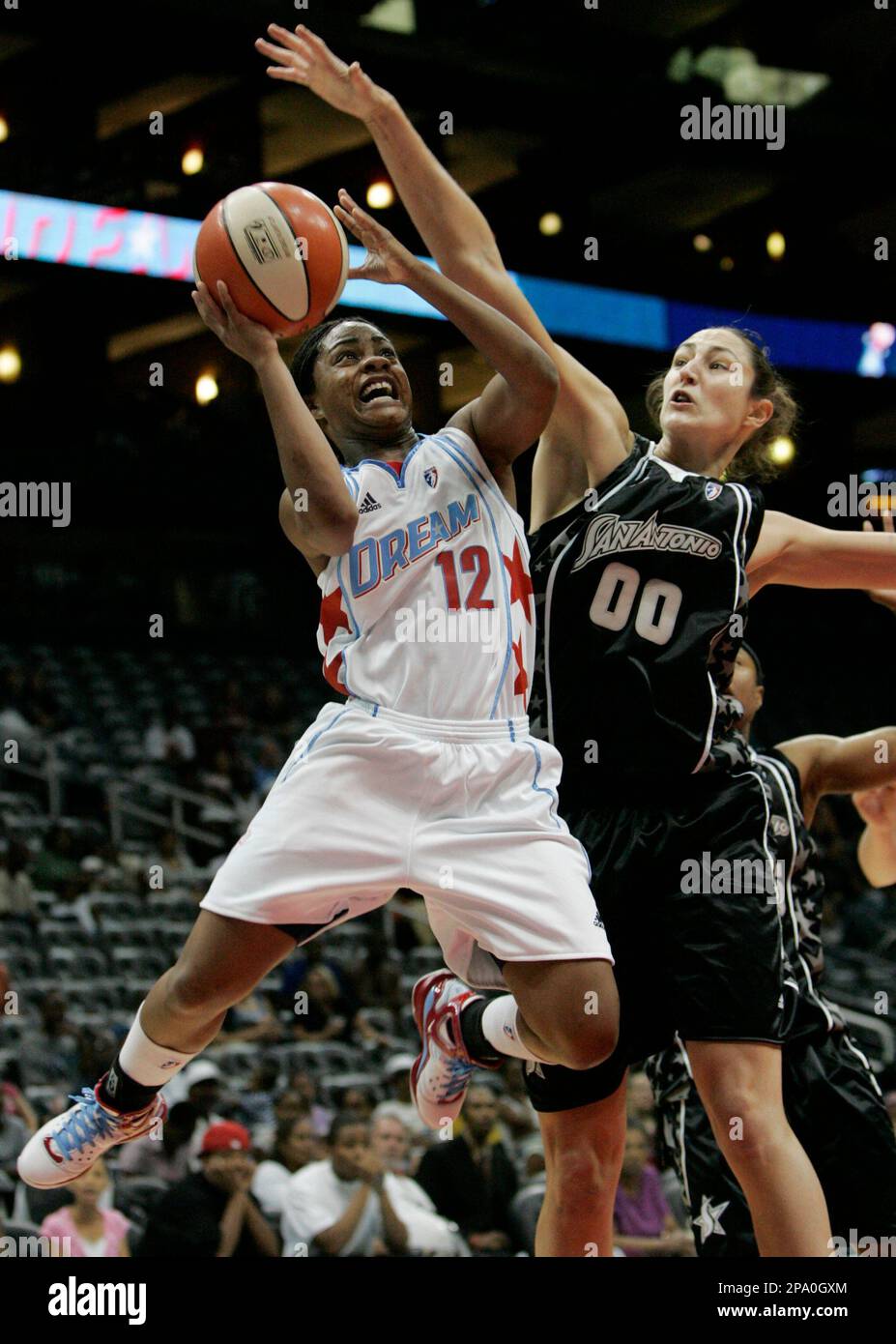 Atlanta Dream guard Ivory Latta (12) goes to the basket while defended ...