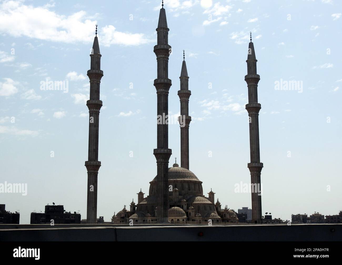 A grand mosque with multiple minarets and domes of different sizes and ...