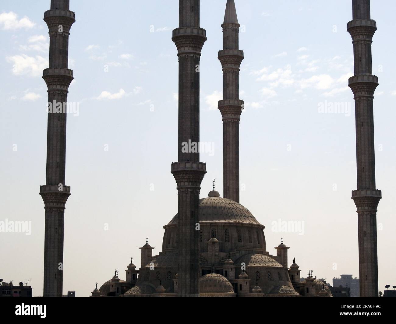 A grand mosque with multiple minarets and domes of different sizes and ...