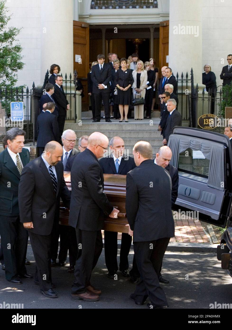 The casket of Tim Russert is carried from Holy Trinity Church following ...