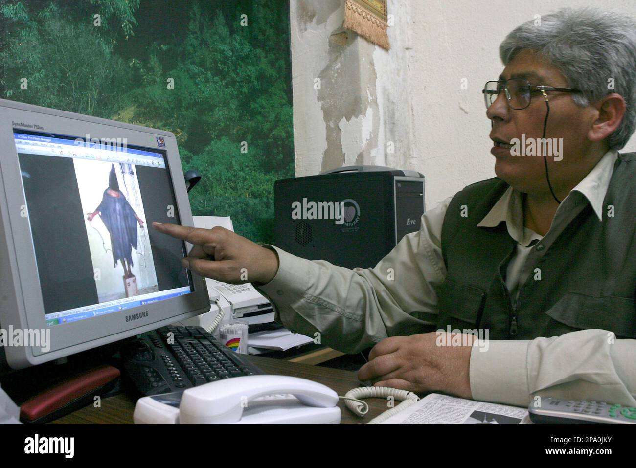 Former Abu Ghraib detainee Ali Shallal al-Qaisi points to his photo ...