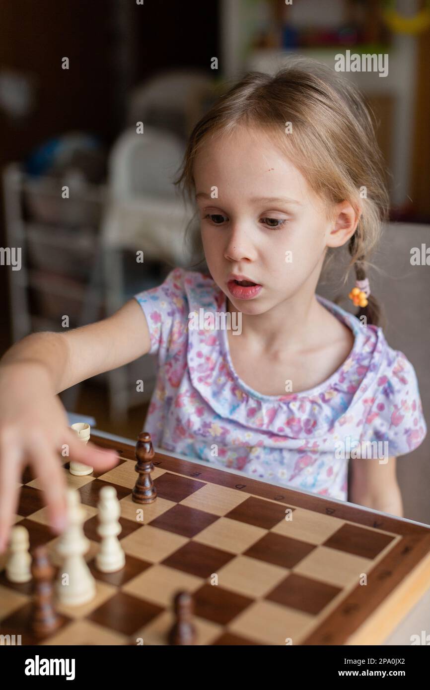 Little girl playing chess at home Stock Photo - Alamy