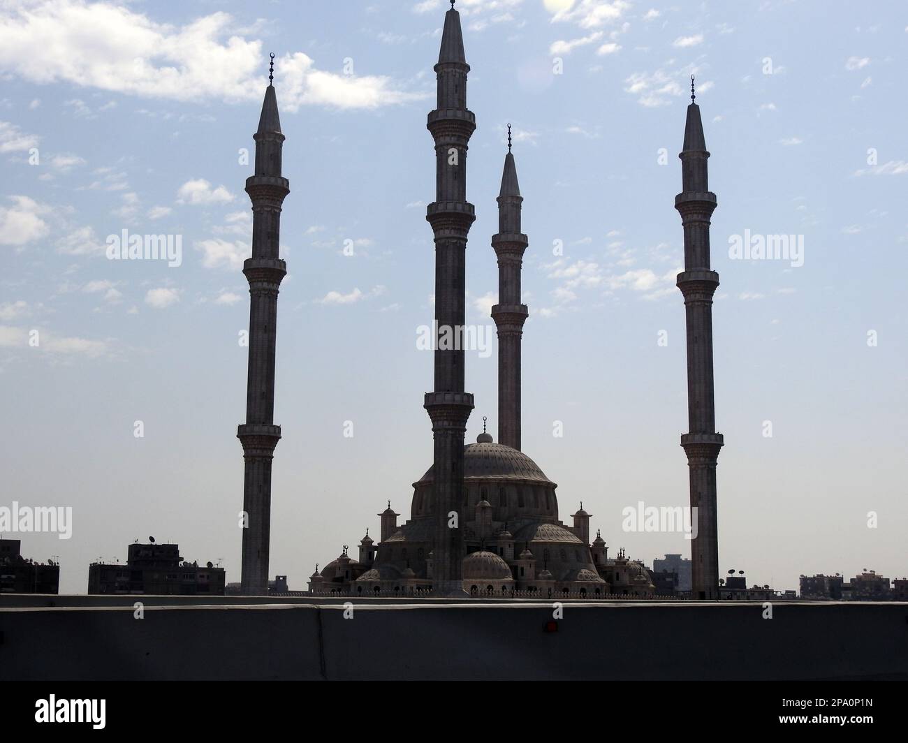 A grand mosque with multiple minarets and domes of different sizes and ...