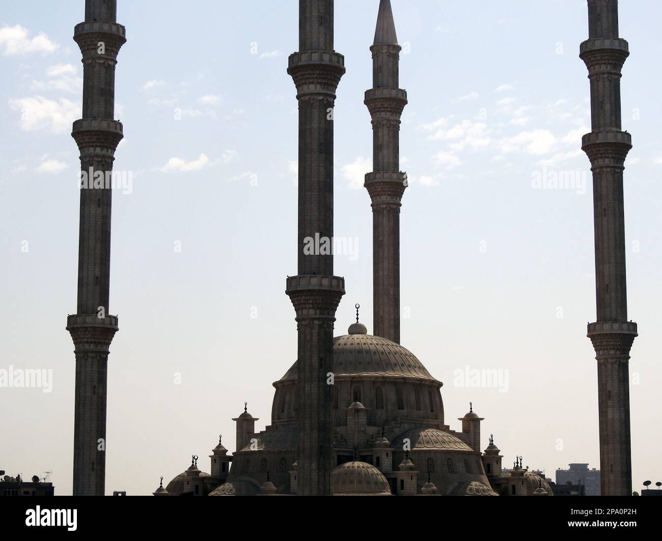 A grand mosque with multiple minarets and domes of different sizes and ...