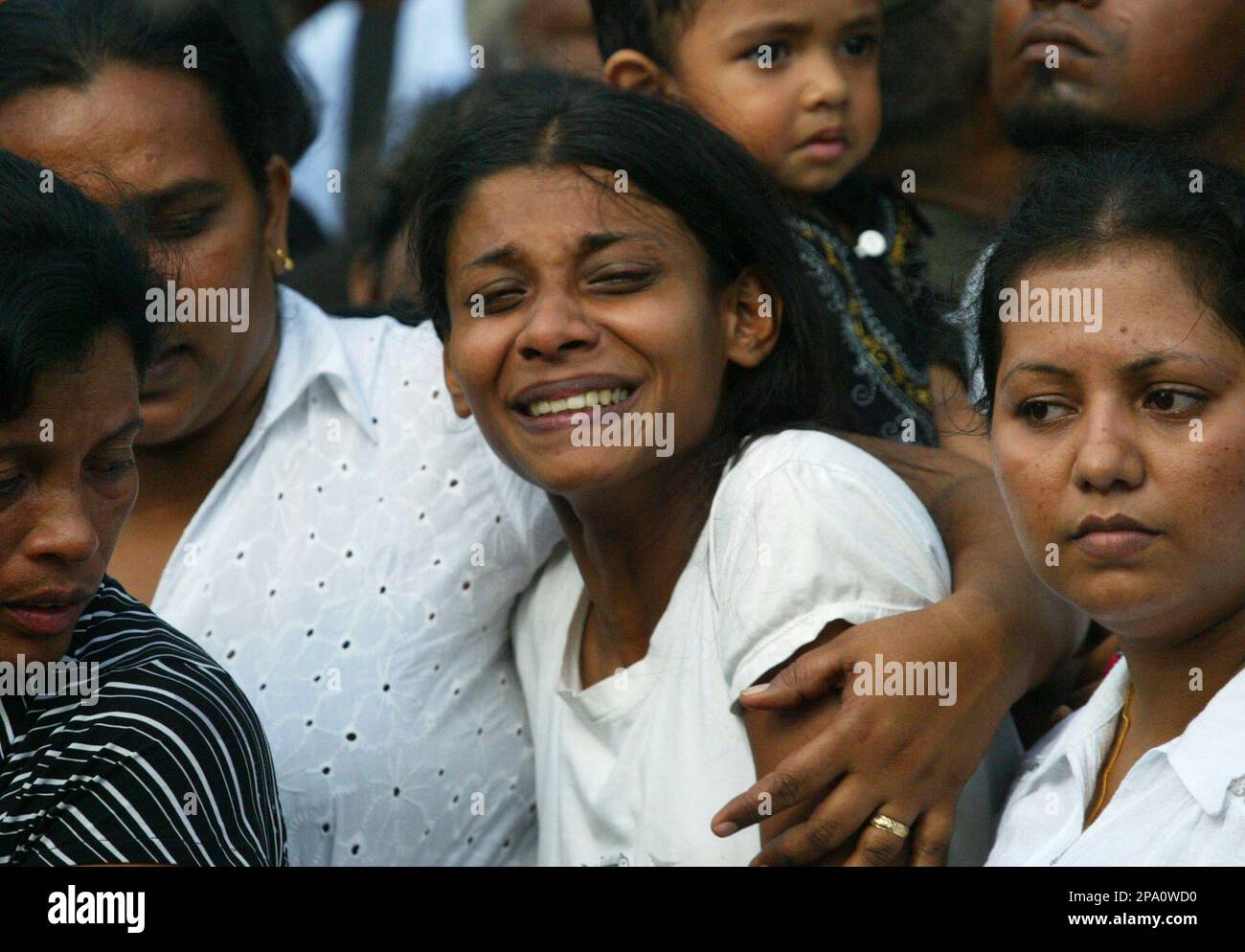 Relatives of Sri Lankan army sergeant Roshan Indika, react, during his ...