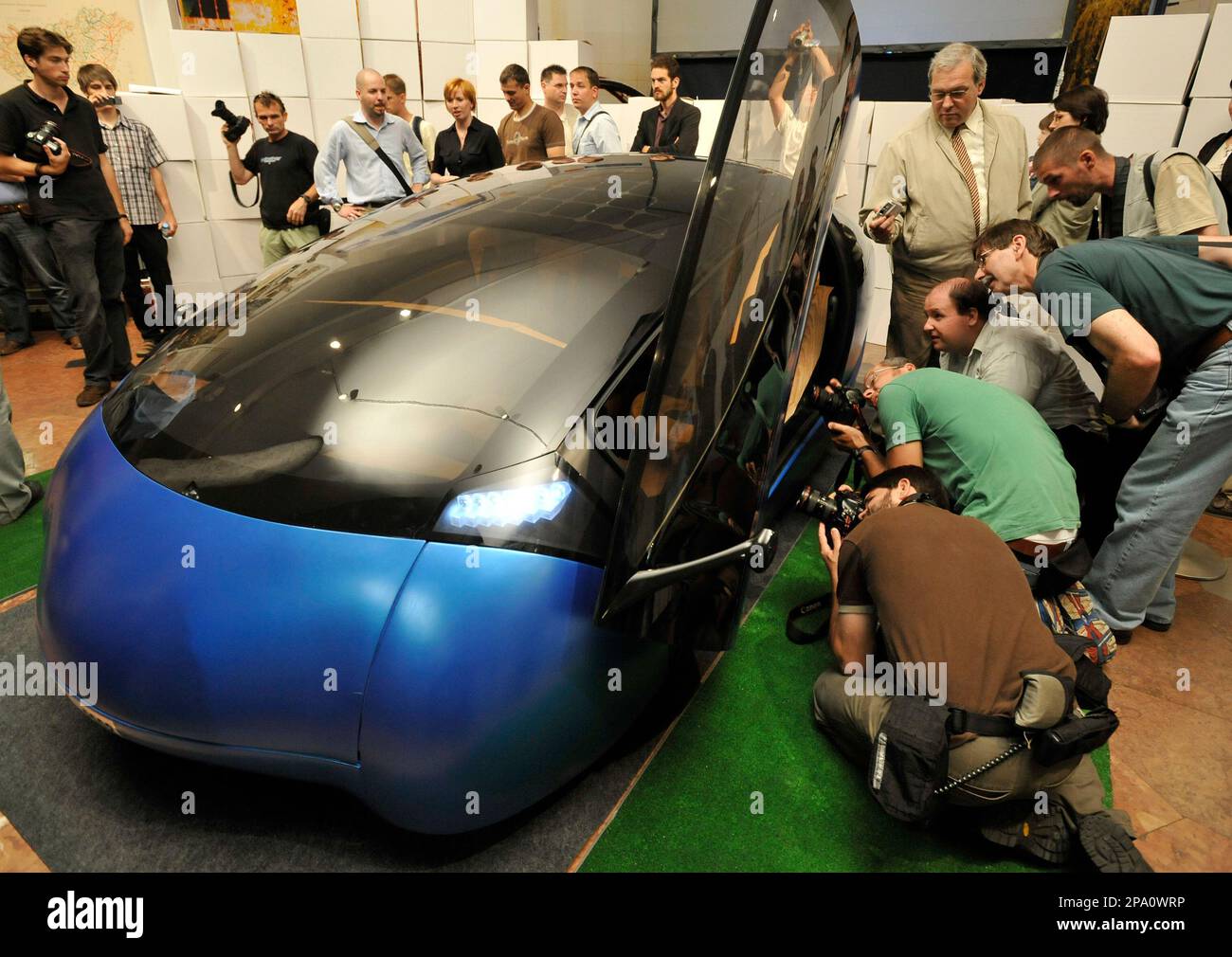 Members of the press observe the first Hungarian hybrid car, named Solo ...