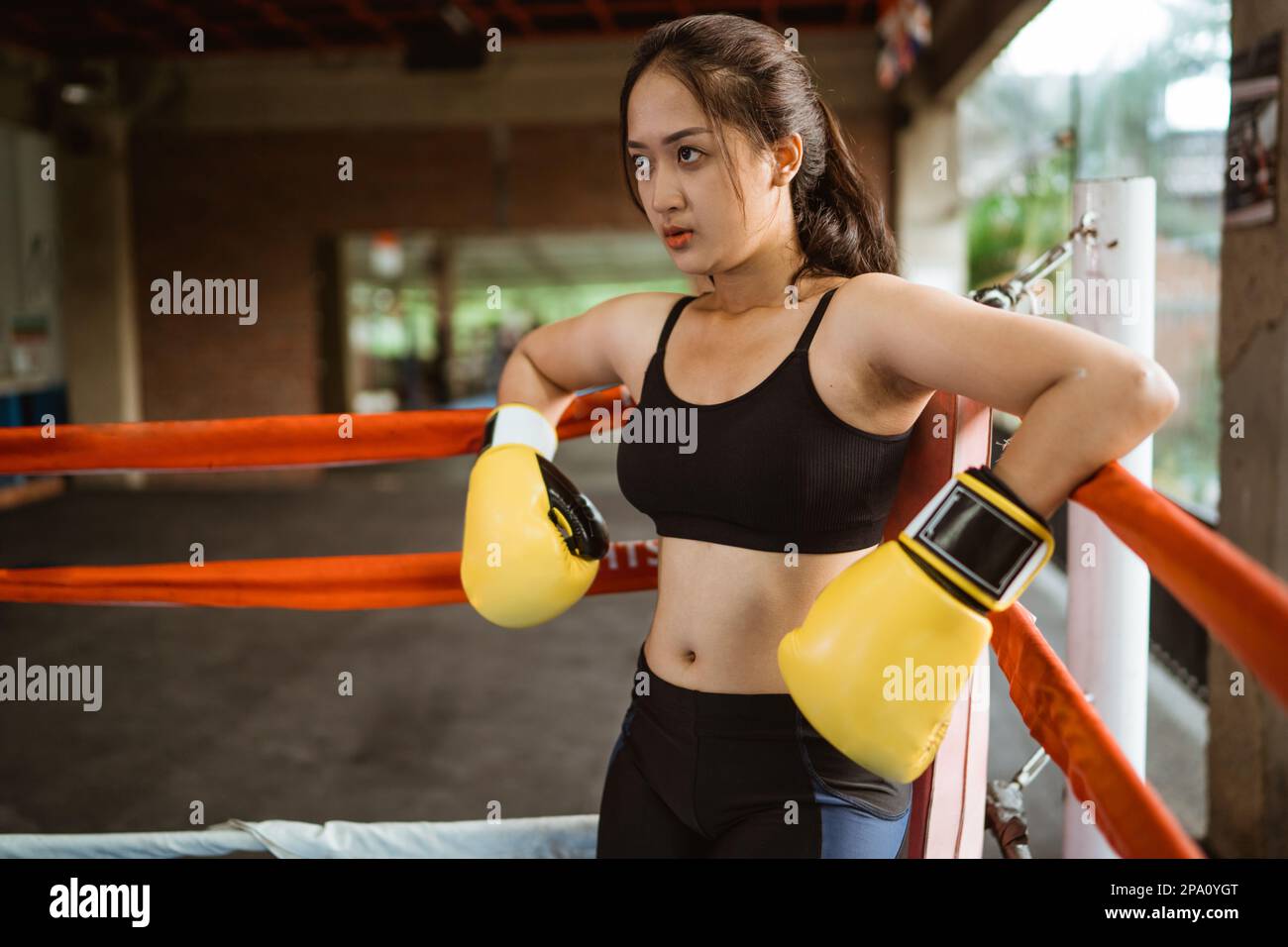 the female boxer standing leaning on the box ring Stock Photo - Alamy